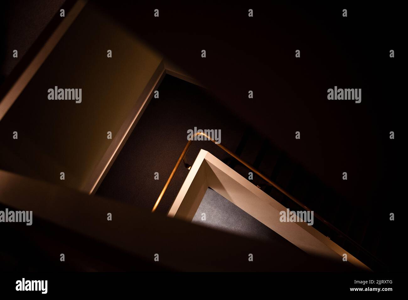 A high angle shot of stairs' design with metallic handrails and ...