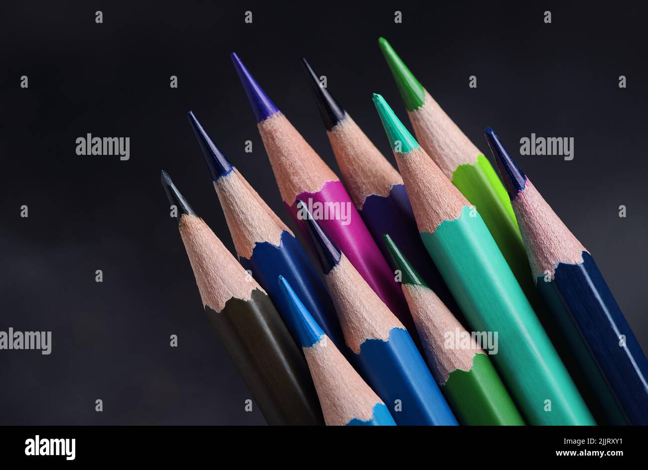 Color pencils in a cool tone on the black background Stock Photo - Alamy