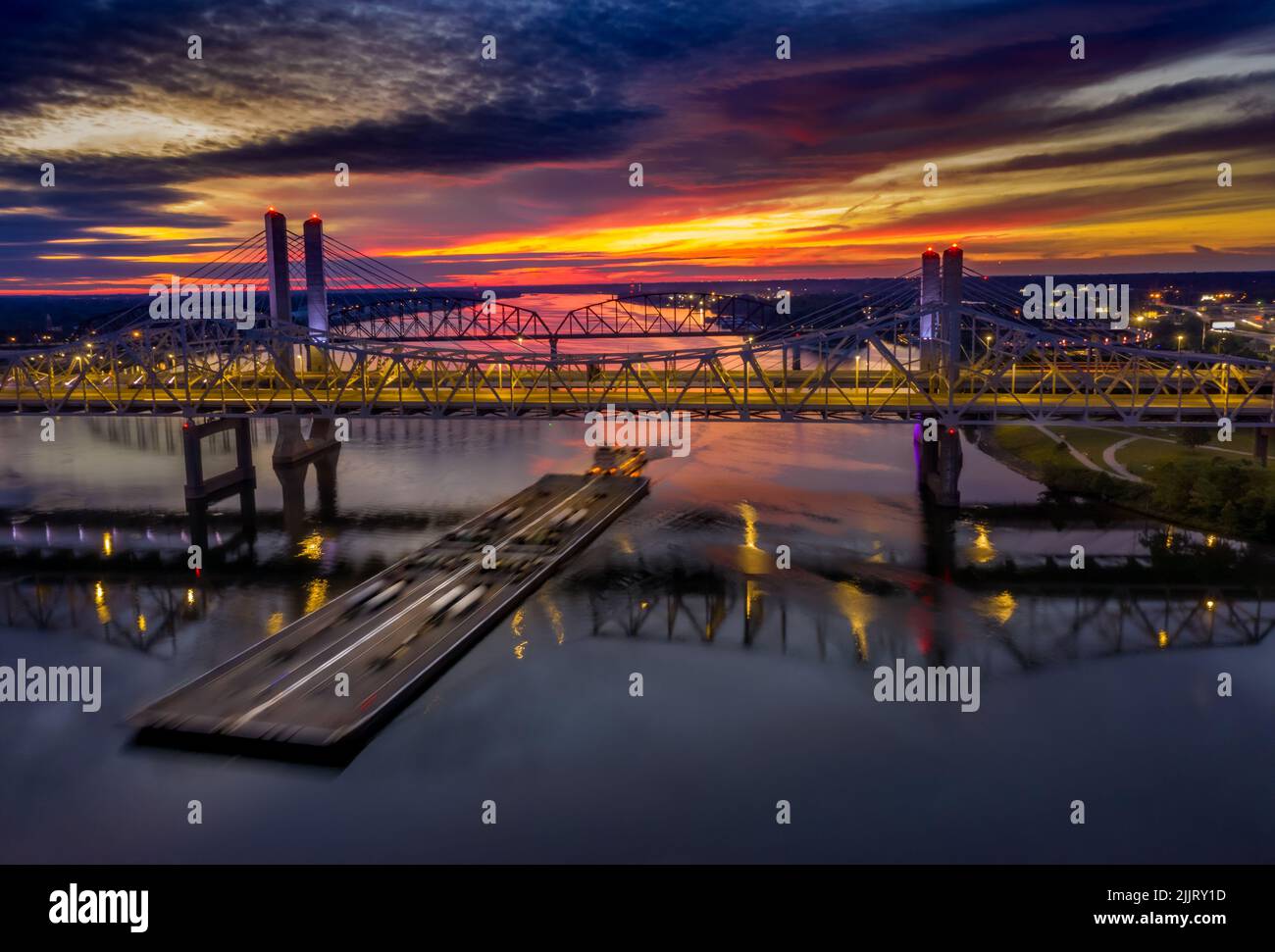 A bird's eye shot of a river barge sailing under a bridge in Ohio river ...