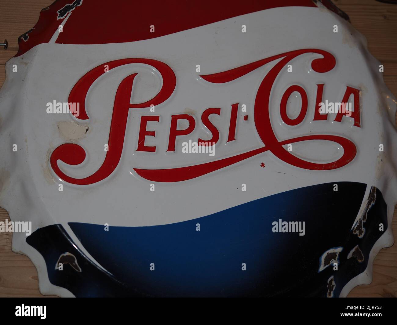 A Pepsi Cola old sign shaped like bottle cap Stock Photo - Alamy
