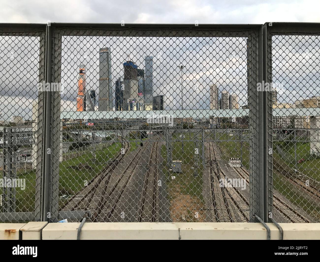 The Moscow City skyscrapers view through a grid taken from a bridge ...