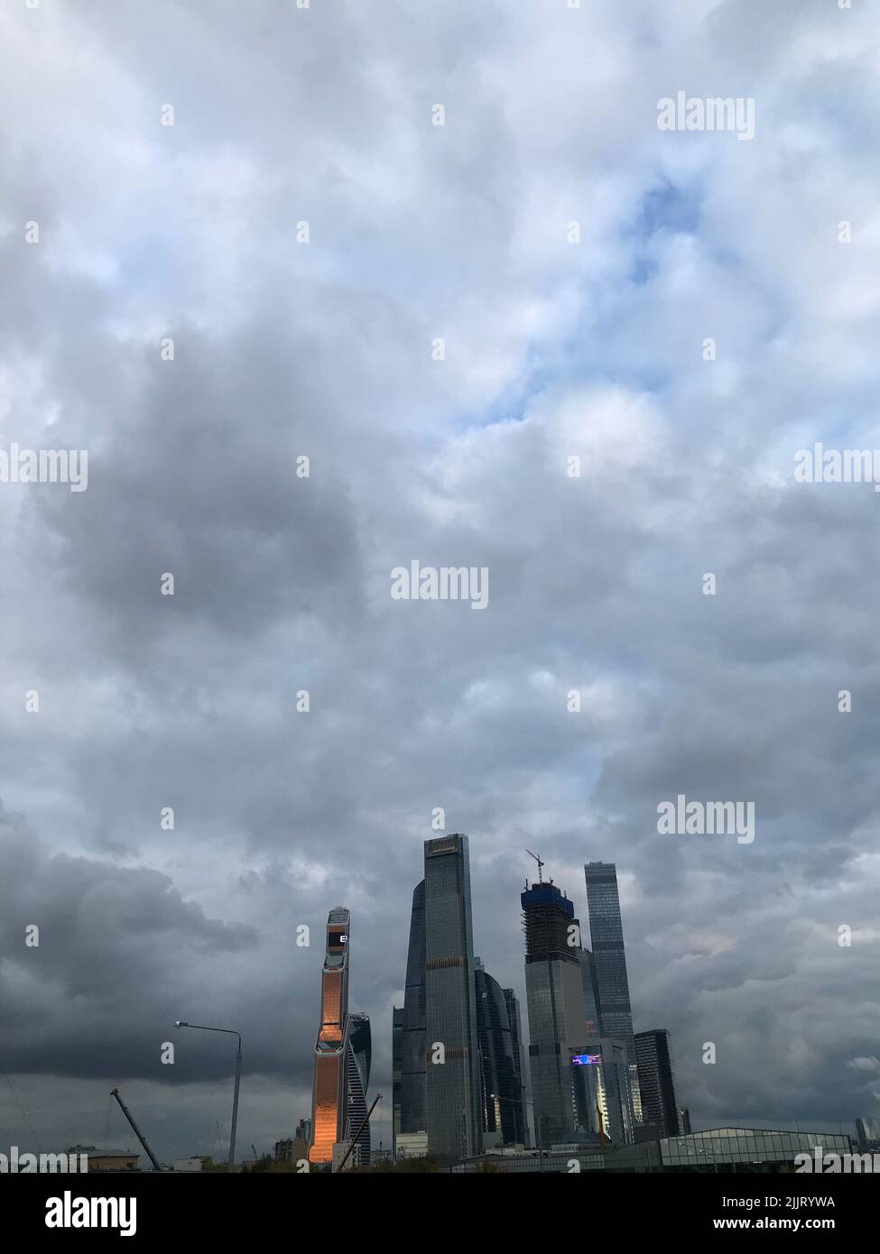 The Moscow City skyscrapers view with the cloudy skyline vertical, low ...