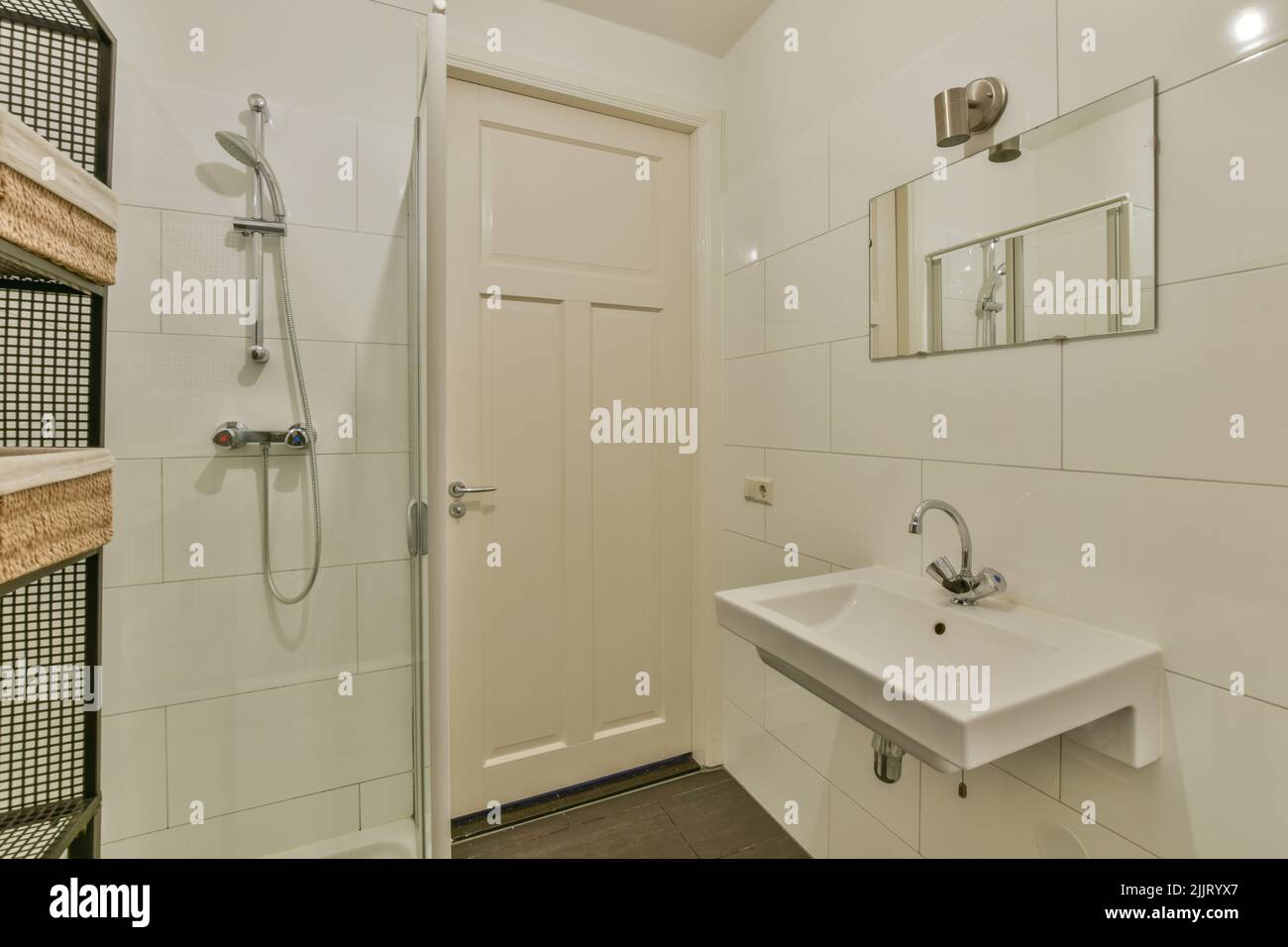 Sinks With Mirrors And Clean Bathtub Located Near Shower Box With Glass