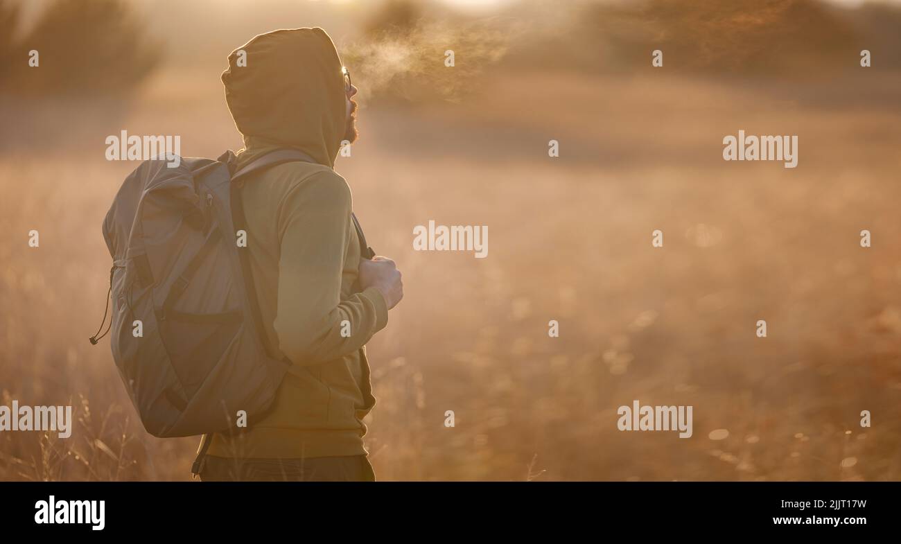 Young handsome man posing in autumn nature. guy standing in field over ...