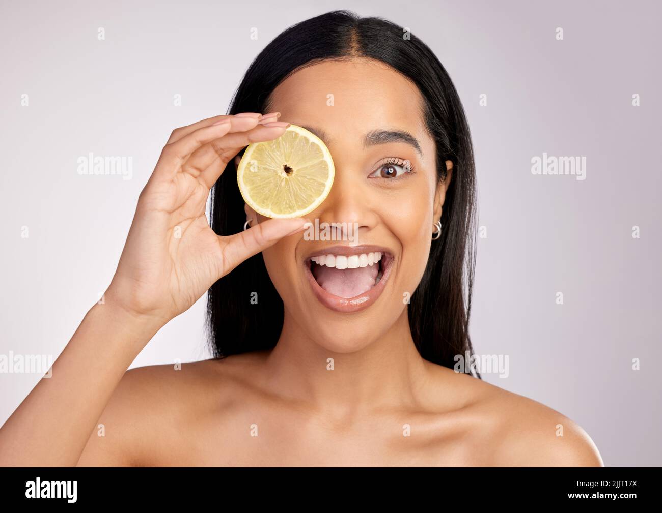 The wonders a lemon can do. Studio portrait of an attractive young ...