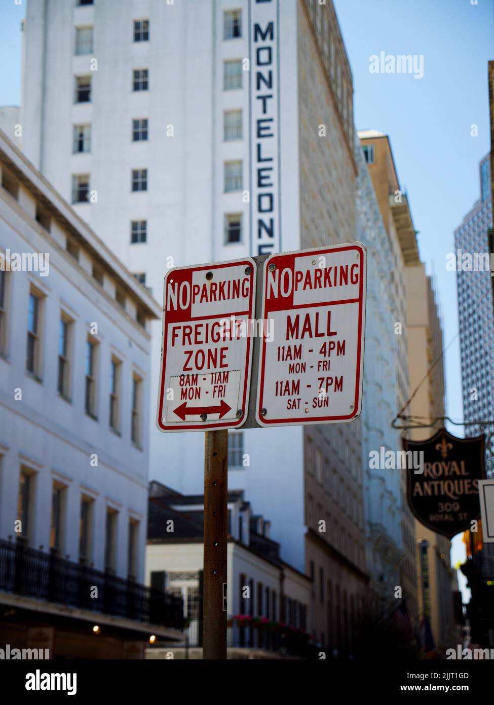 A vertical shot of parking restriction signs on Royal Street during ...