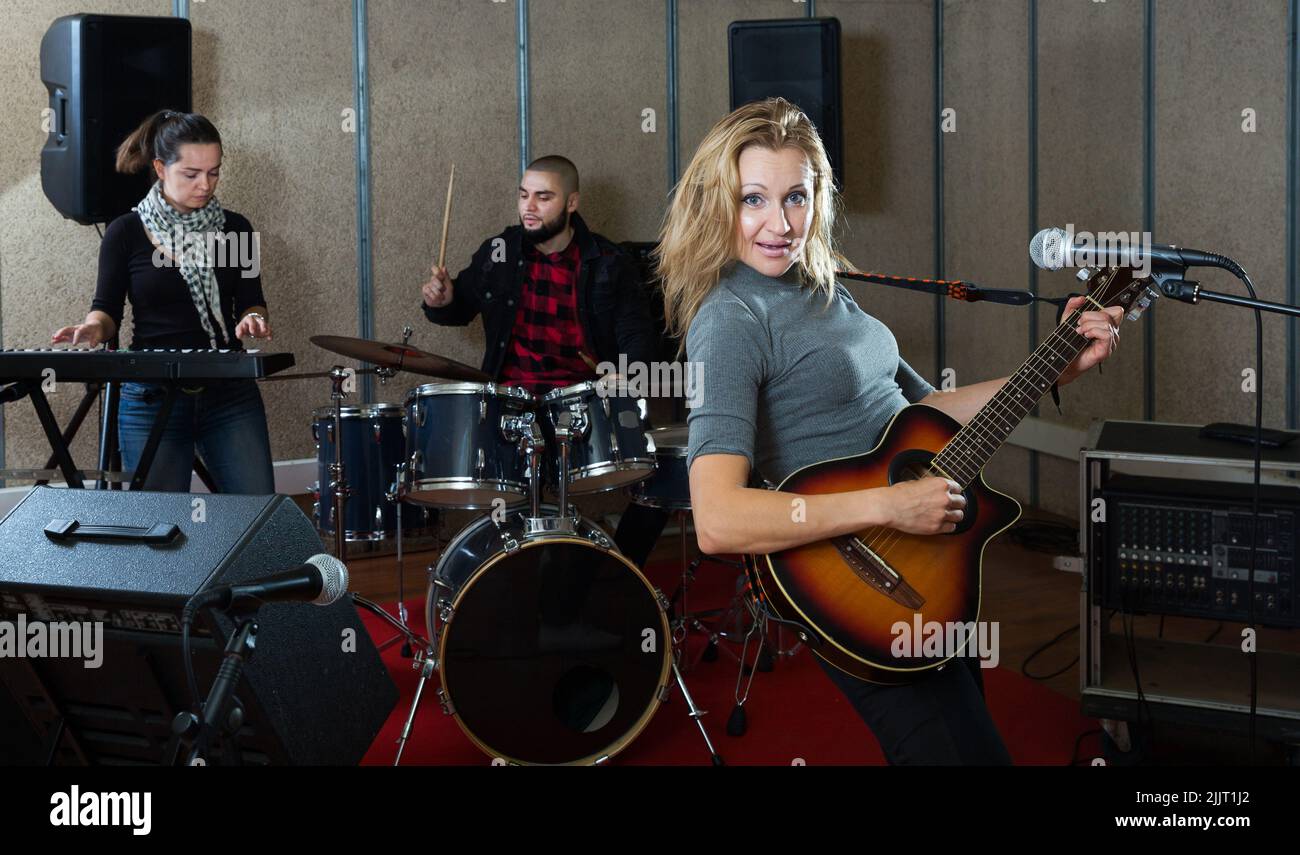 excited girl rock singer with guitar during rehearsal Stock Photo - Alamy