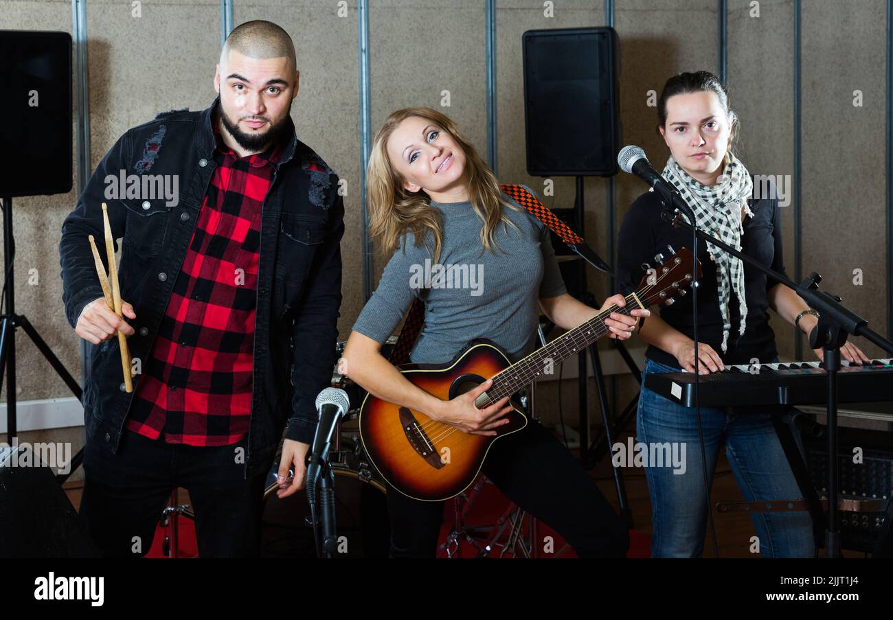 group of rock musicians posing with instruments Stock Photo - Alamy