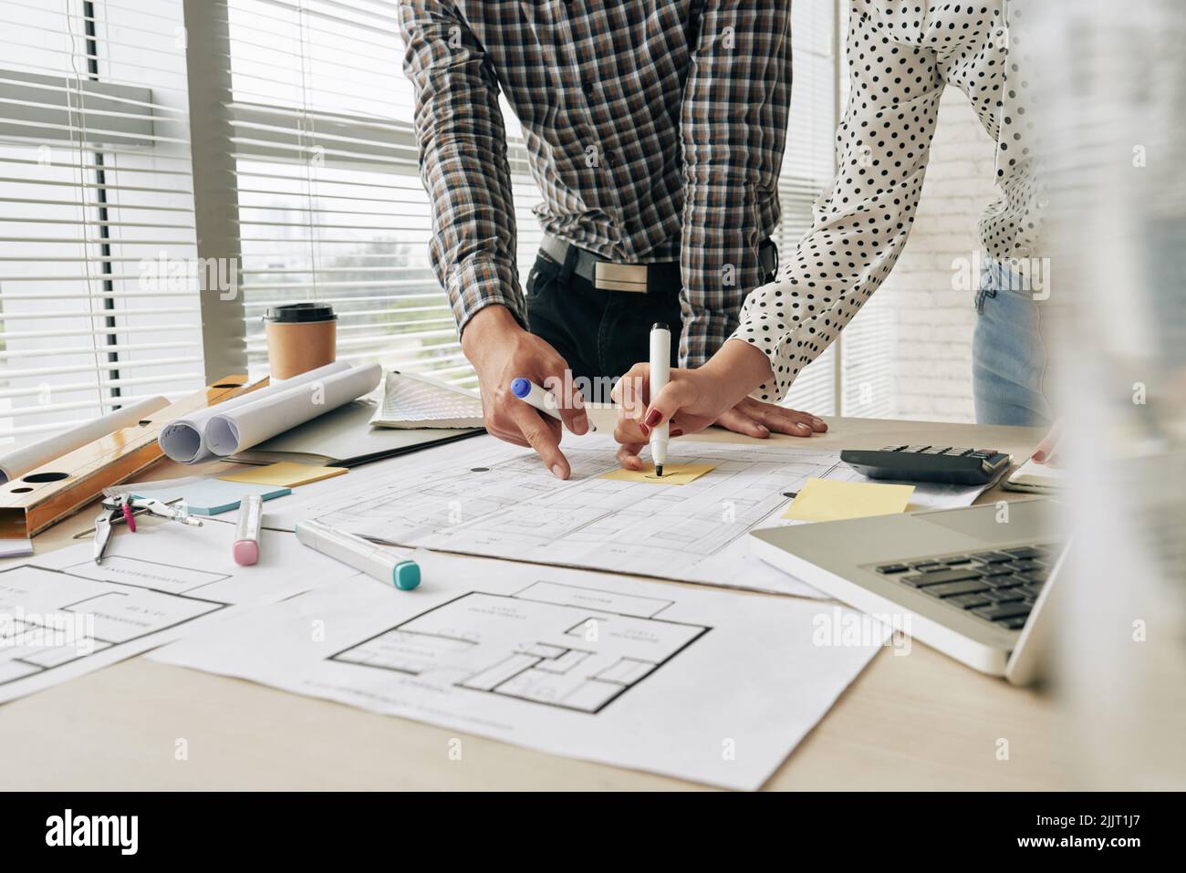 Close-up image of architects working on building blueprint Stock Photo ...