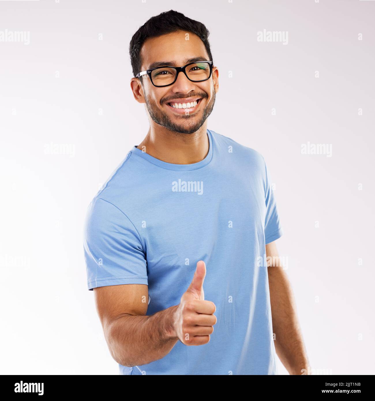 One has to be positive. Studio shot of a young man showing a thumbs up ...