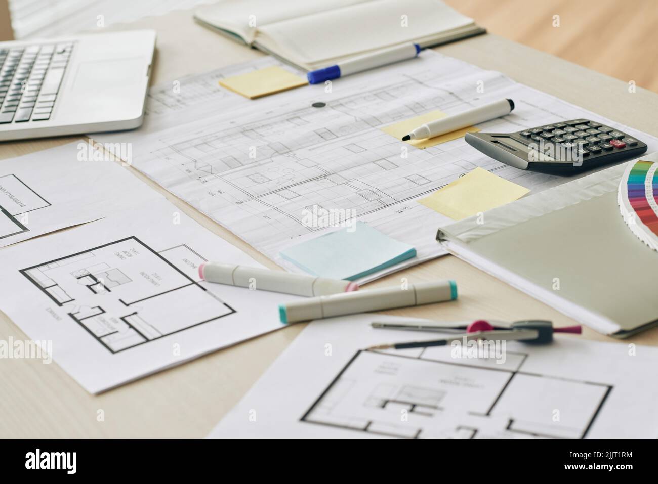 Blueprints and markers on table of architect Stock Photo - Alamy