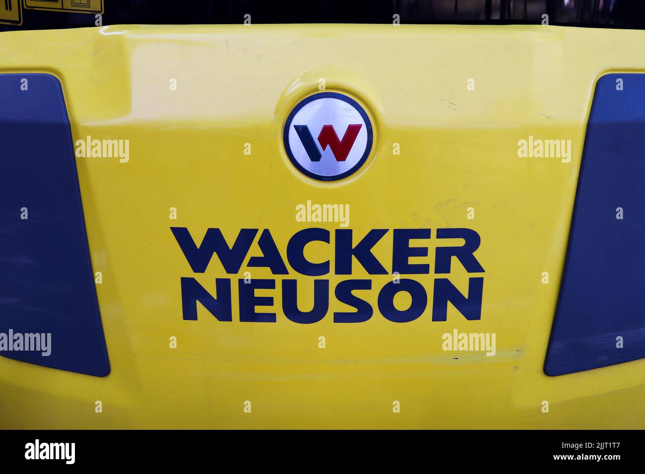 The logo of the company Wacker Neuson on a small yellow excavator Stock ...
