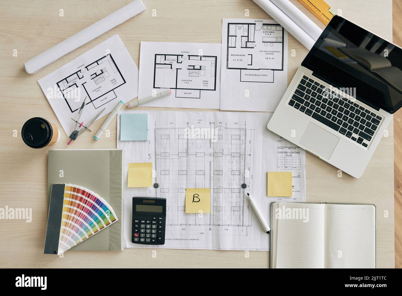 Plans and blueprints on table of interior designer, view from above ...