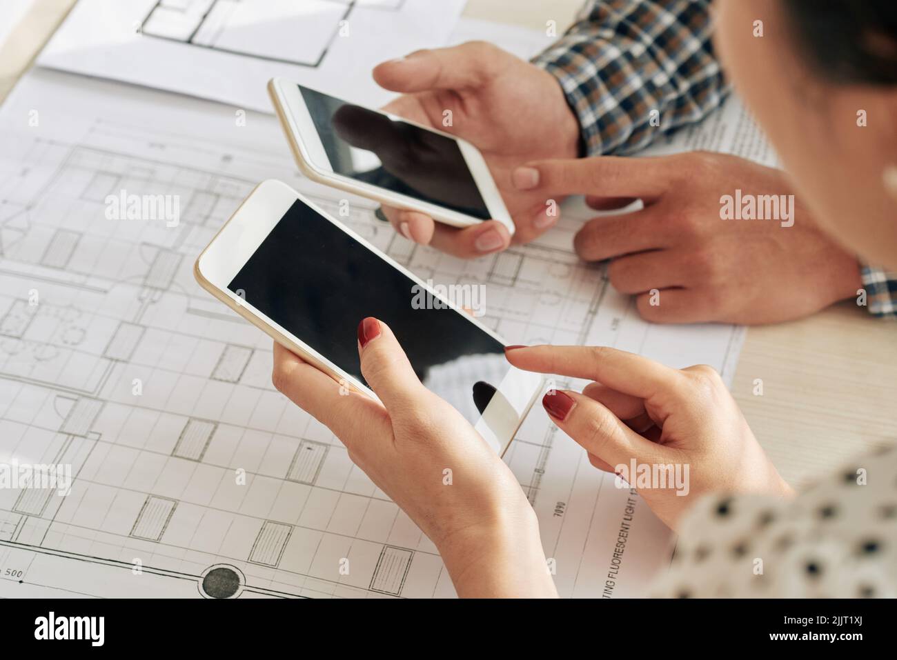 Hands of business people checking messages in their smartphones Stock ...