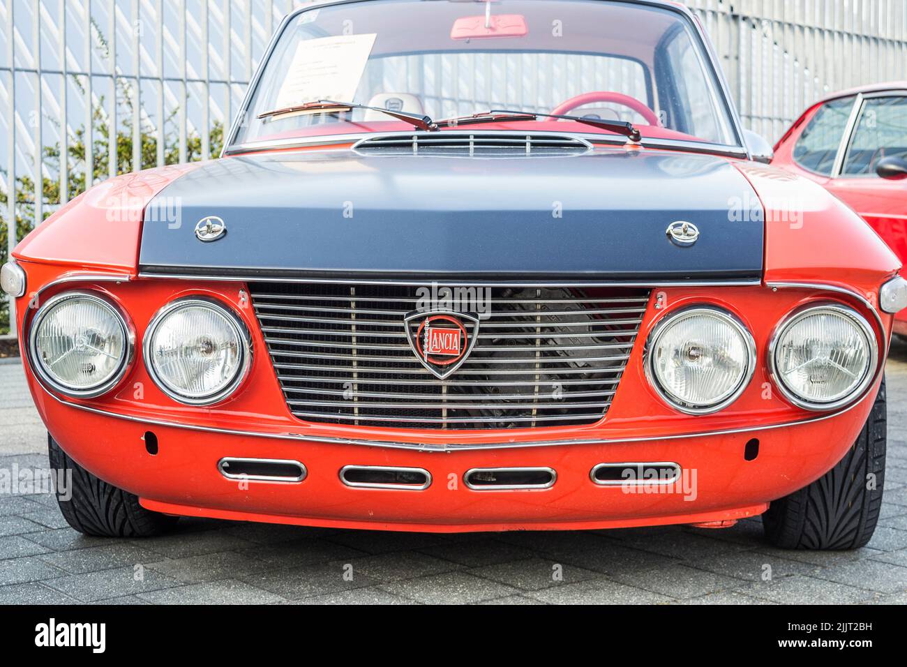 A red Lancia Fulvia coupe displayed on a classic car exhibition in ...