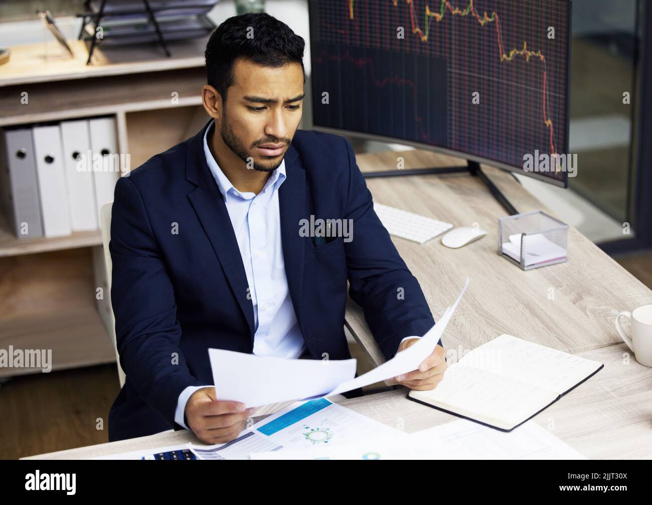 Stressed businessman trading on the stock market in a financial crisis ...