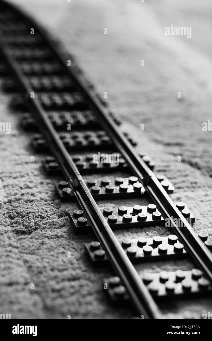 A closeup of a Lego brand plastic toy track on a carpet floor Stock ...