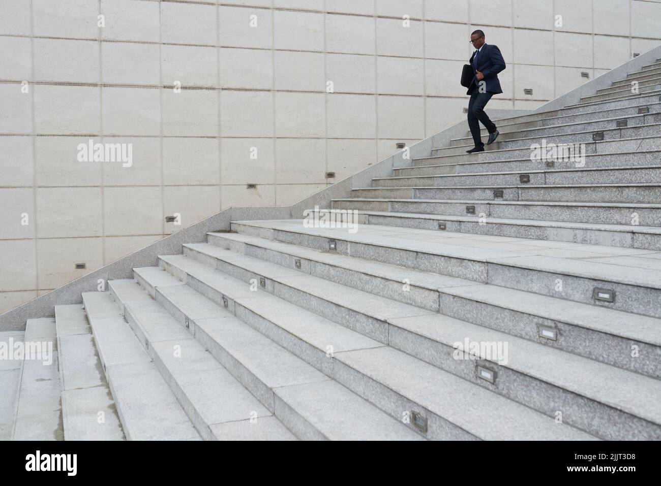 African-American business executive going down the stairs Stock Photo ...