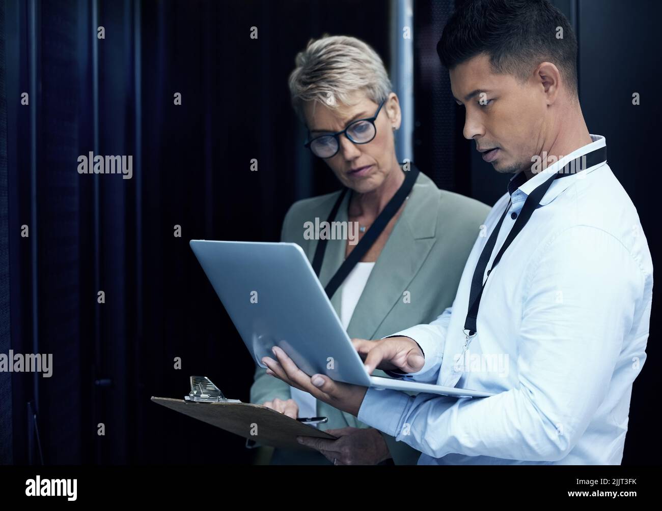 Teaming up to take on any IT infrastructure. two technicians working ...