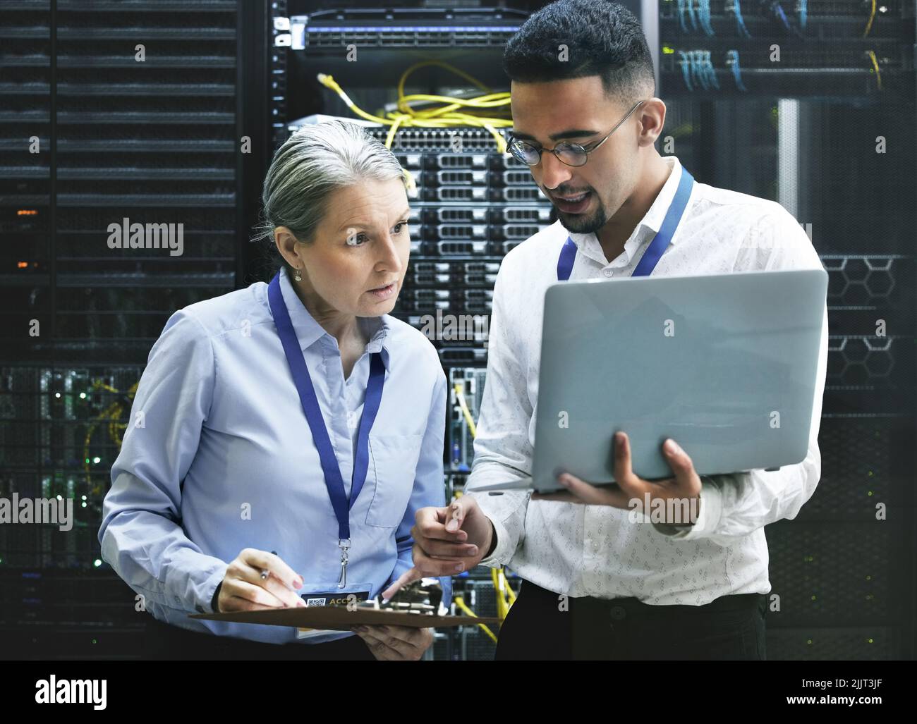 Connecting you is what they do. two technicians working together in a ...