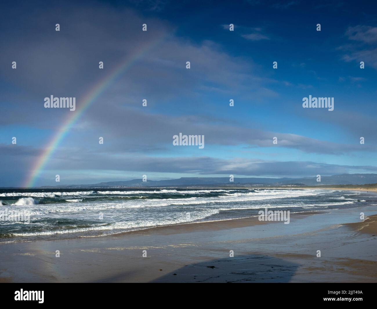 Partial rainbow and winter sunshine over Port Kembla surf beach Stock ...
