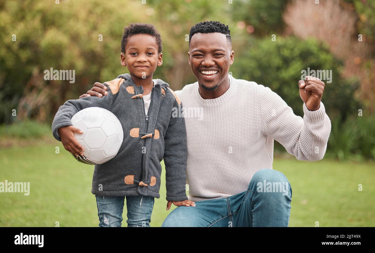 Dad will always cheer him on. Portrait of a father and his son playing ...
