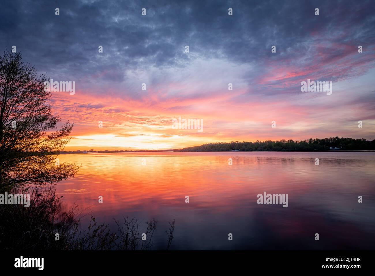 A beautiful shot of a colorful sunset over a river in the evening Stock ...