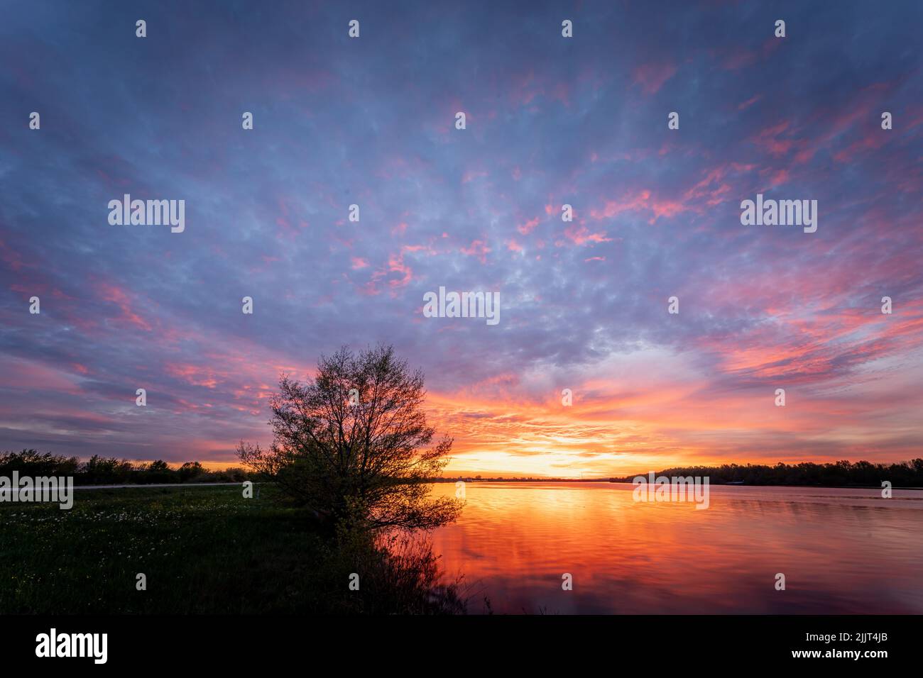 A beautiful shot of a colorful sunset over a river in the evening Stock ...
