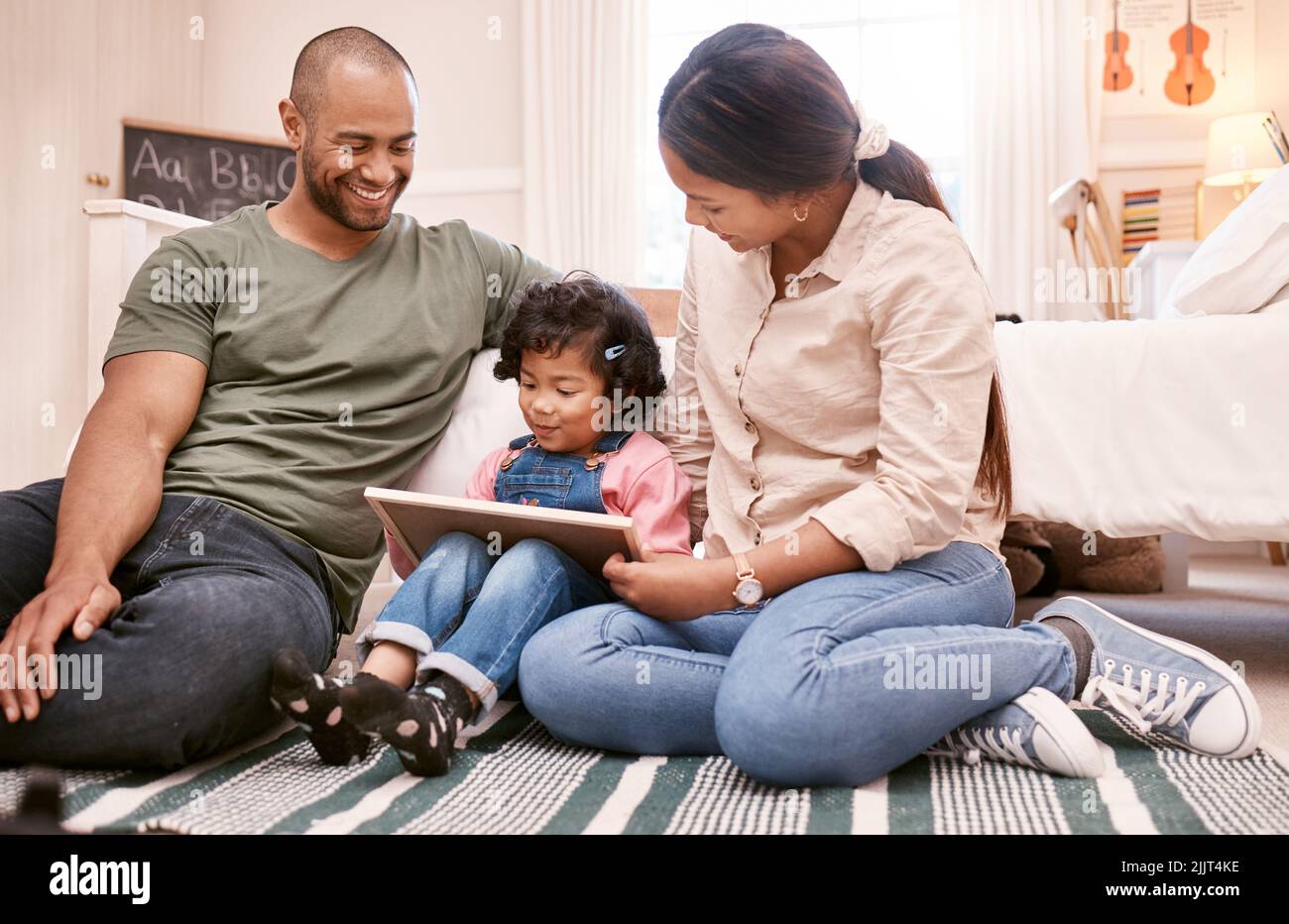 Its family bonding time. a young family using a digital tablet at home ...