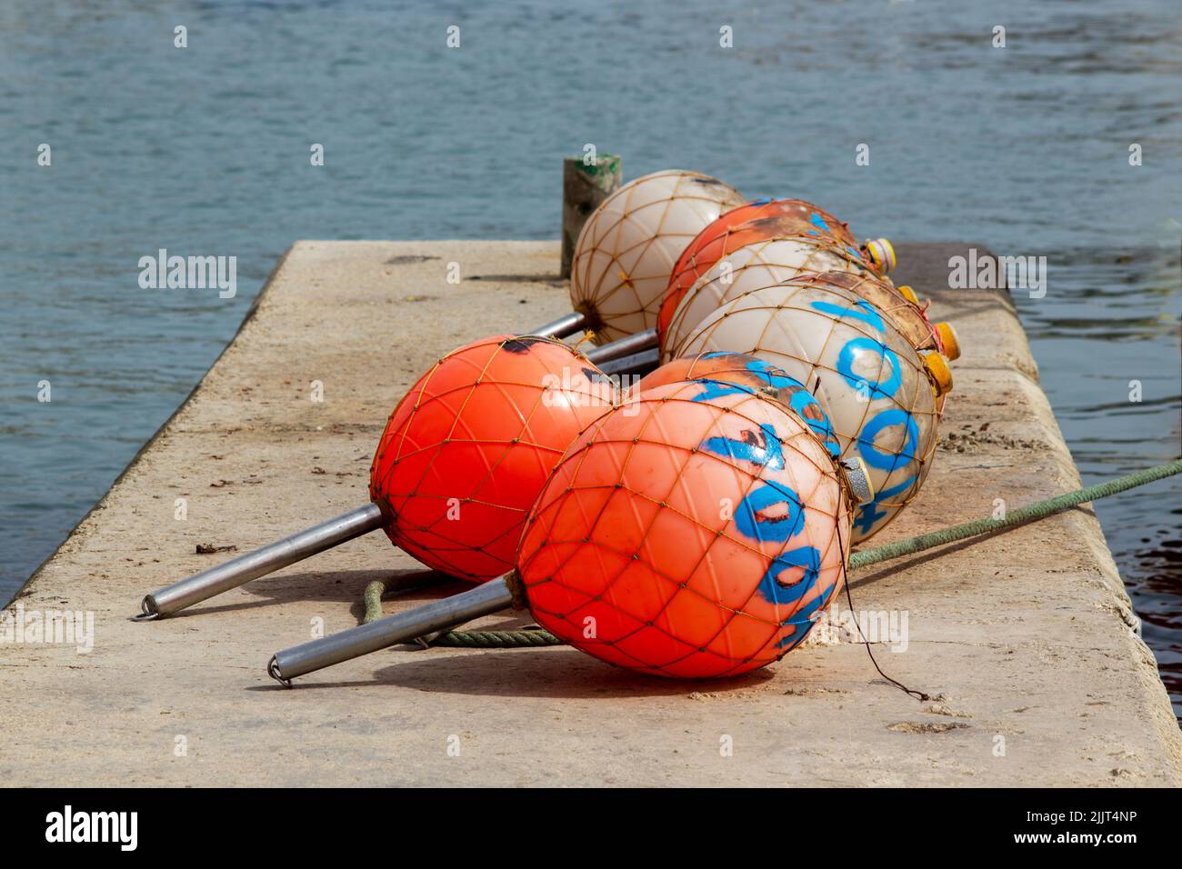 A close-up shot of fishing floats on a pier Stock Photo - Alamy