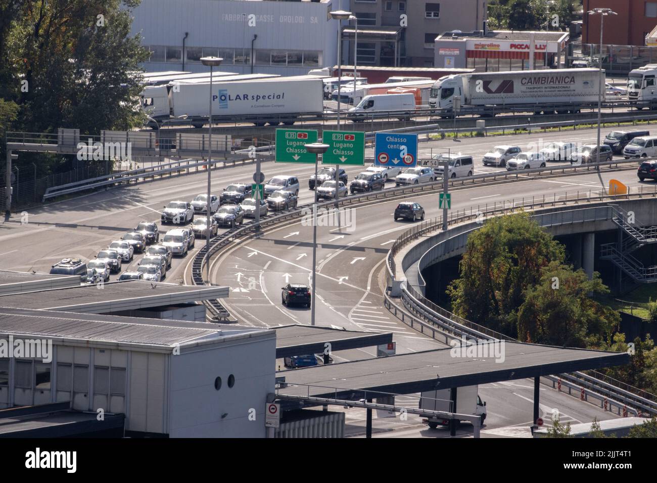 A shot of the cars and trucks over the bridge of Chiasso Highway with ...