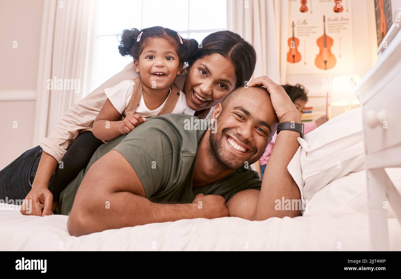 Always put family first. a young family relaxing at home Stock Photo ...
