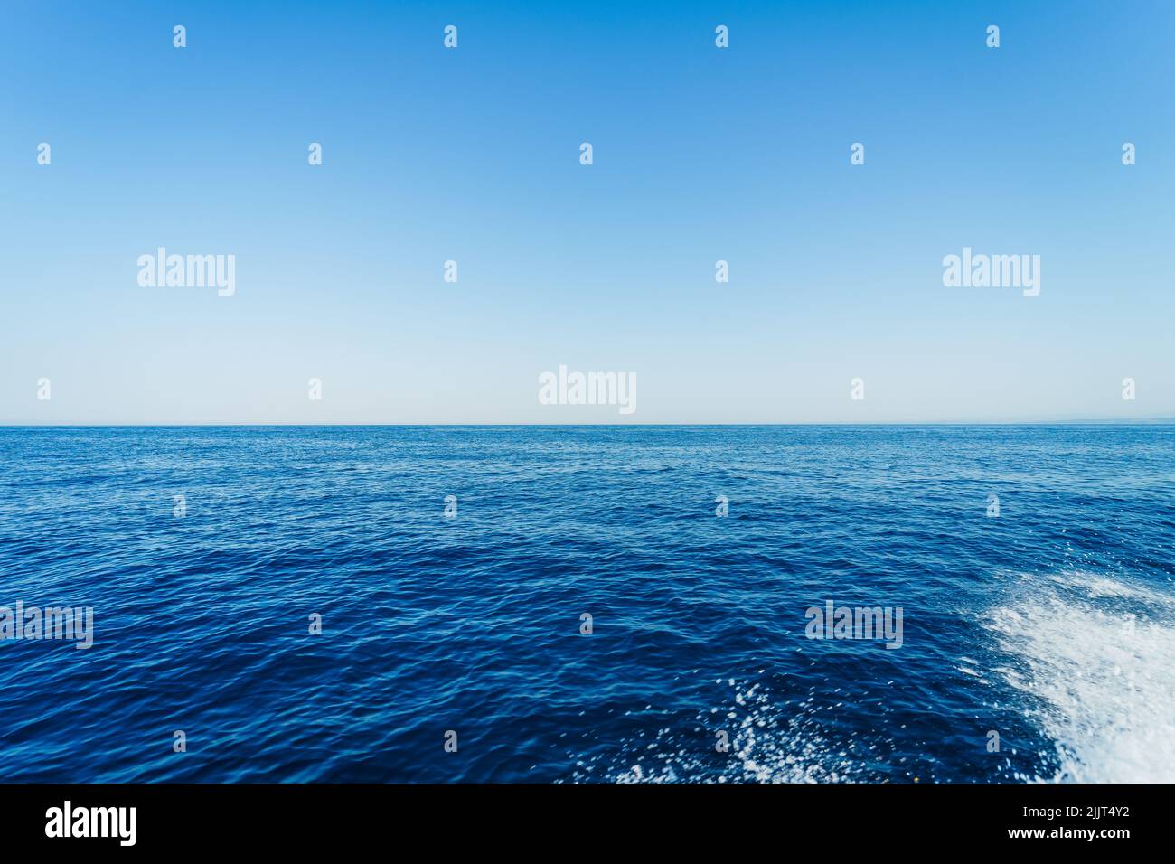 A beautiful seascape from a cruise boat under a blue sky Stock Photo ...