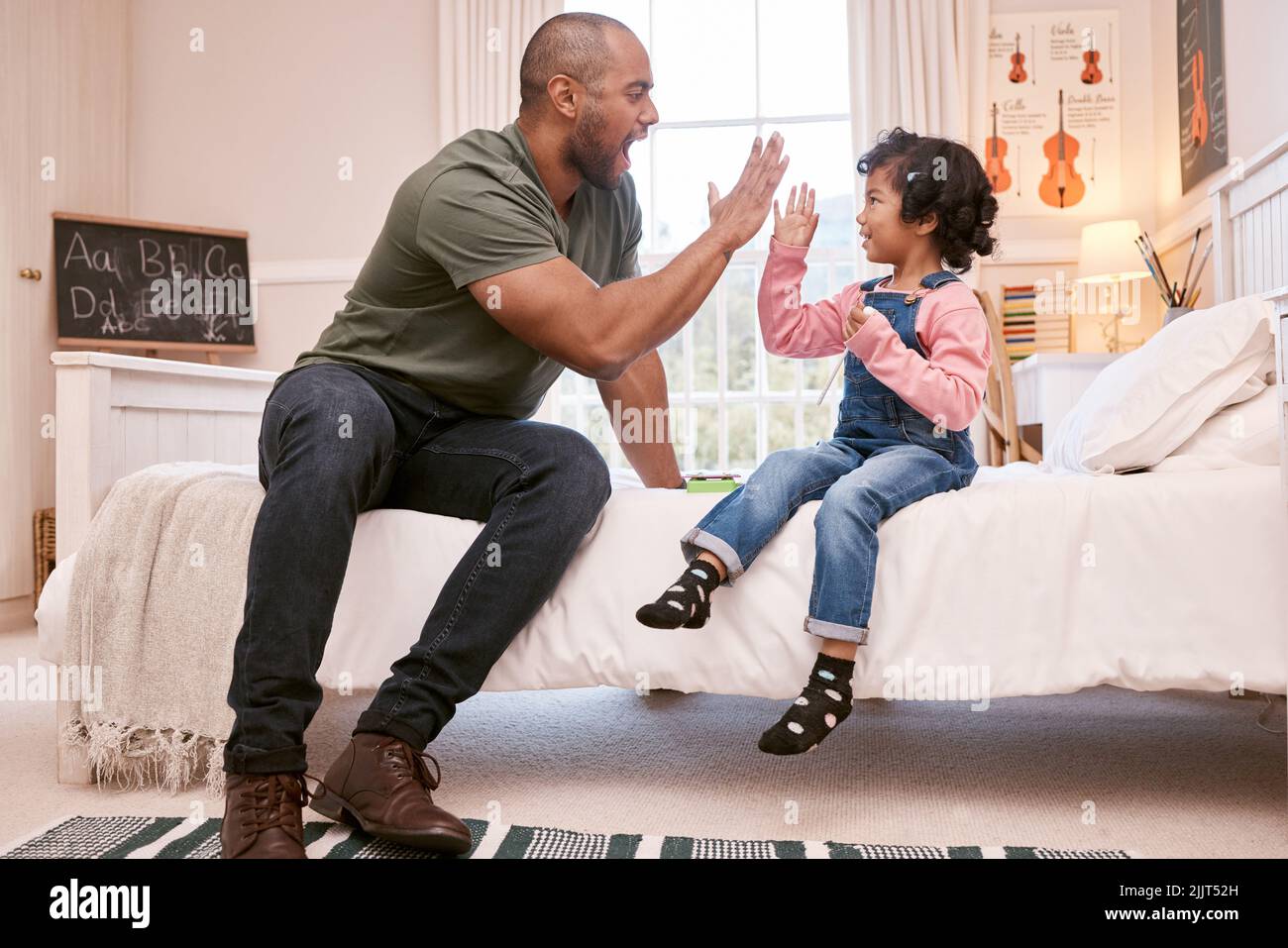 You deserve a high five. a young father and daughter giving each other ...