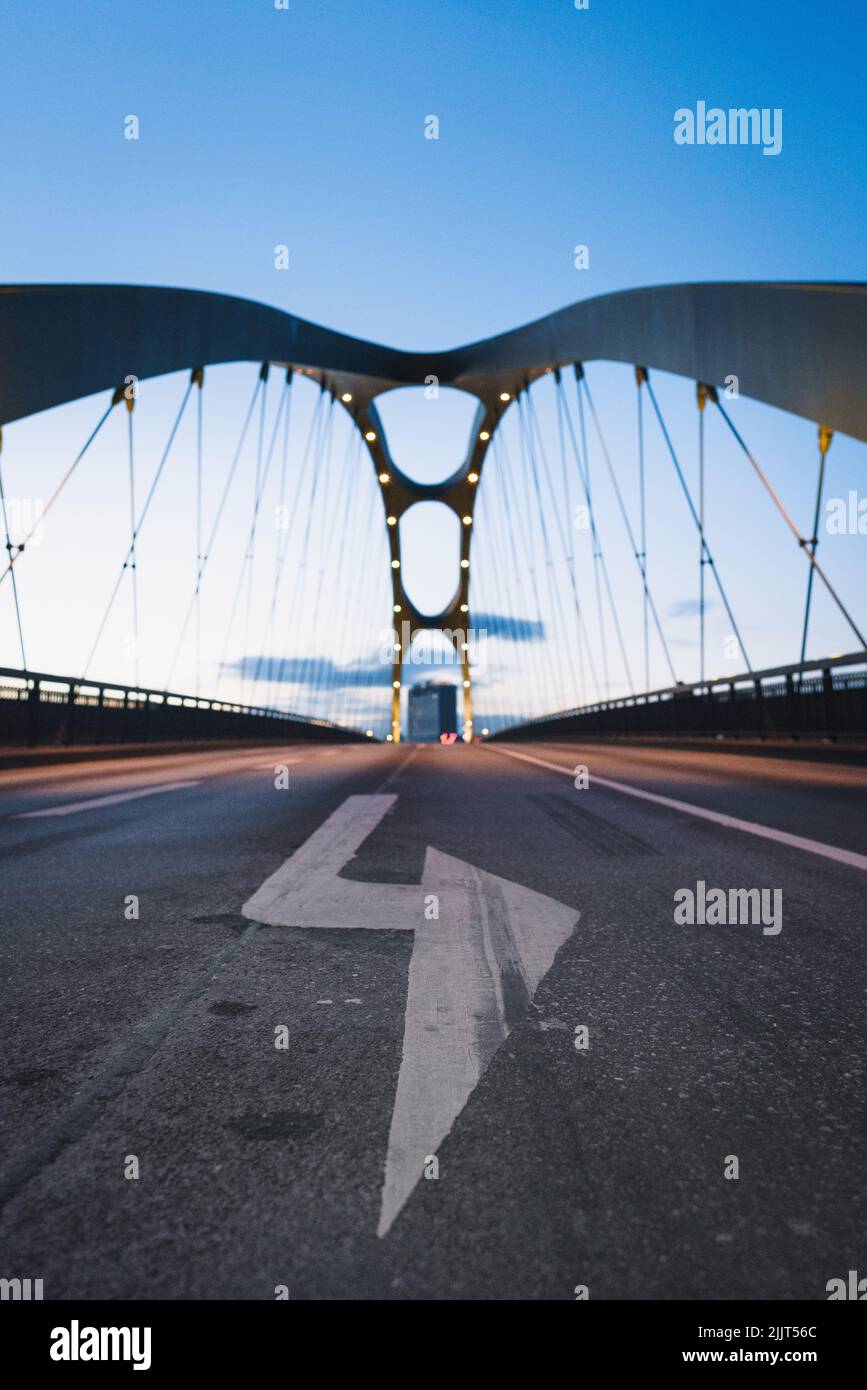 A vertical shot of a bridge and a huge arrow pointing on the right ...