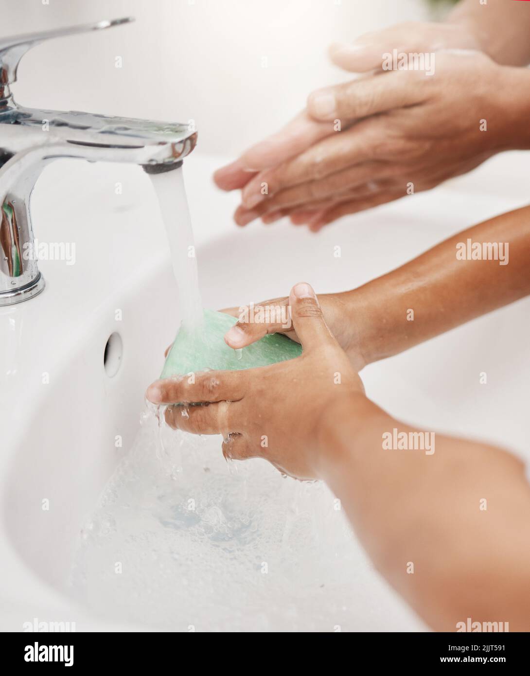 Learning all about good hand washing habits. Closeup shot of a father ...