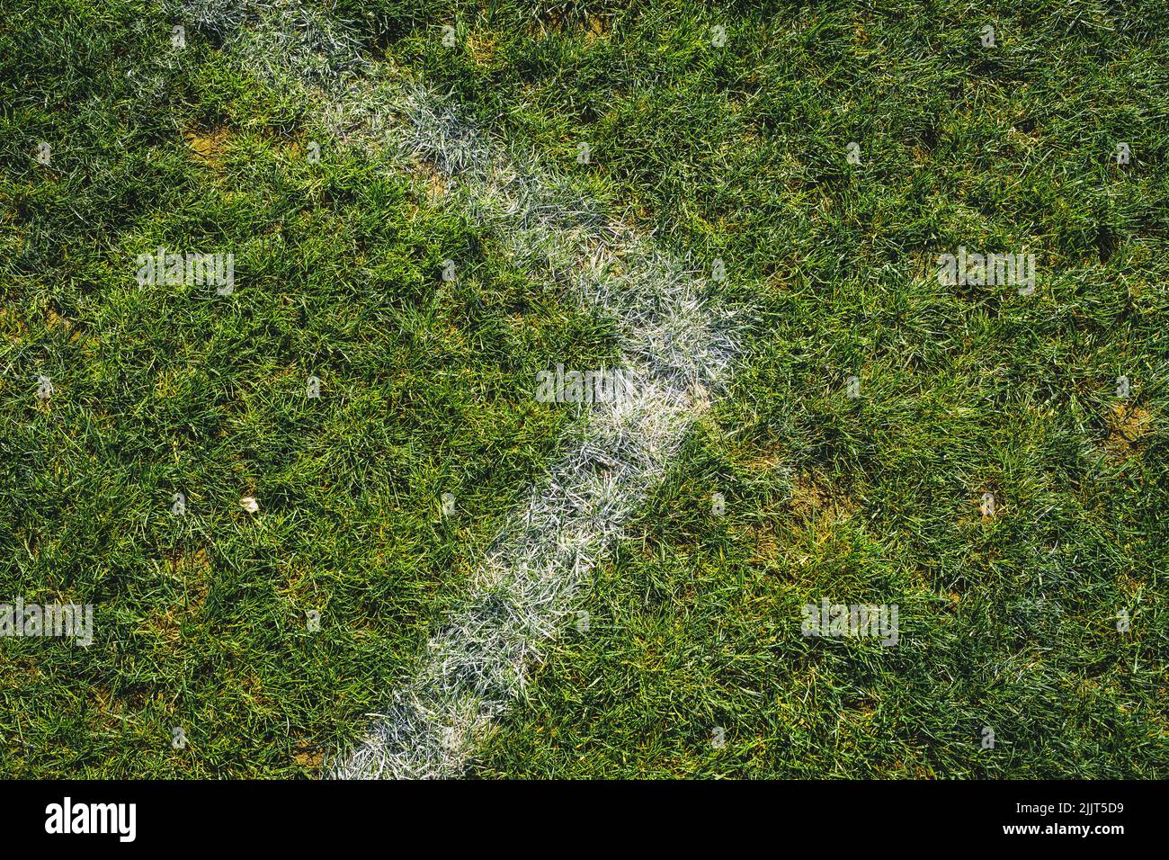 A low angle shot of a grass field with white zigzag line Stock Photo ...