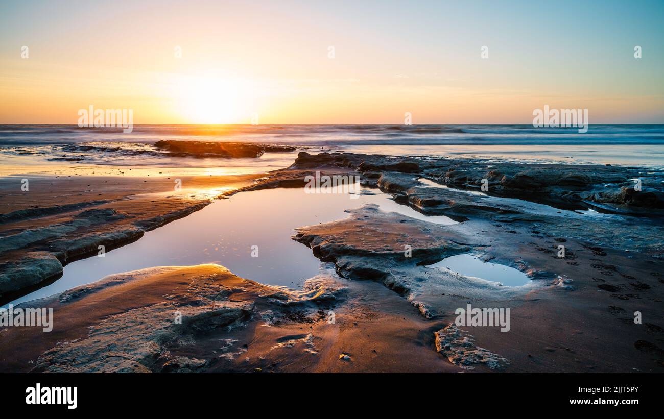 A beautiful scene of the Waiiti Beach in New Zealand at sunset Stock ...