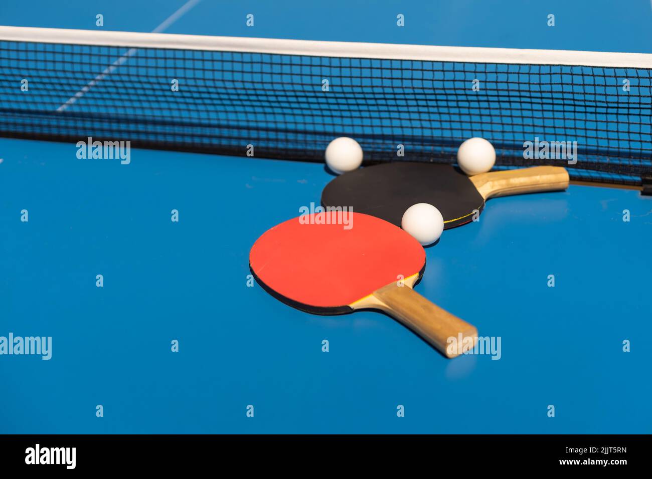 Ping pong table, rackets and balls in a sport hall Stock Photo - Alamy