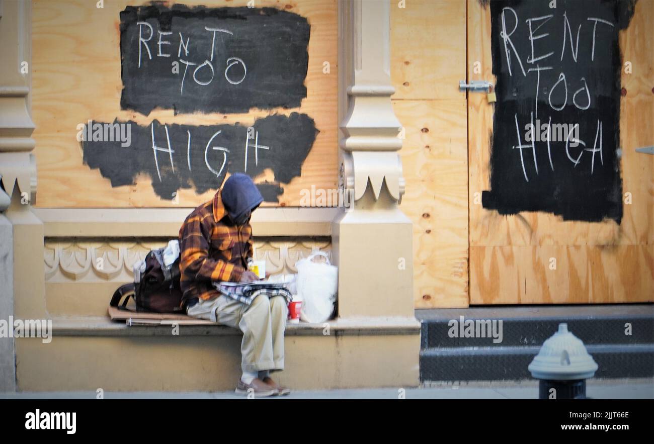 A view of a homeless person in front of graffiti wall Stock Photo - Alamy