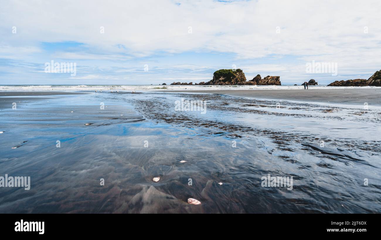 A beautiful view from the shallow sea water of the rock formations on ...