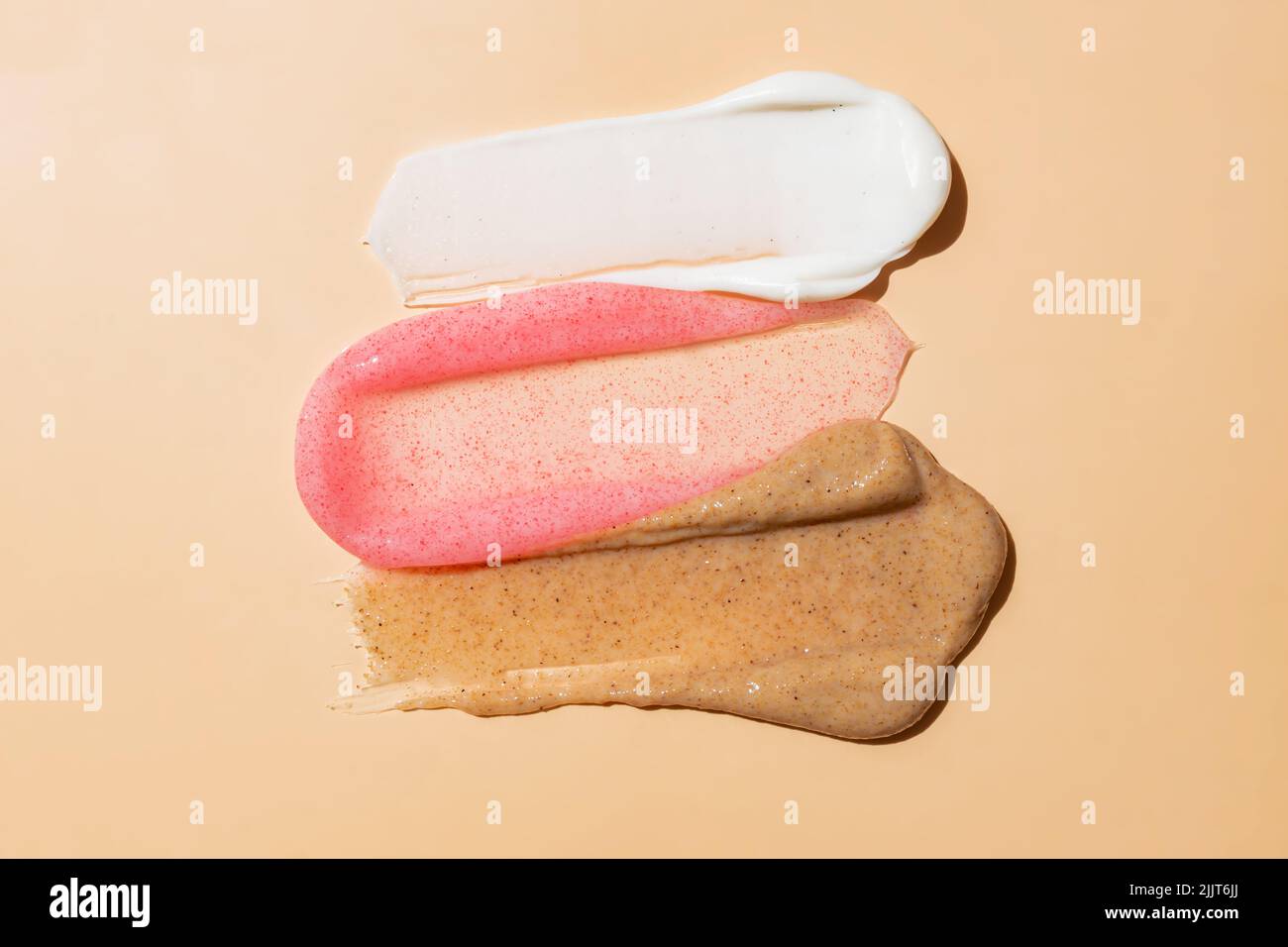 three types of face scrub on beige background. Face body skin peeling ...