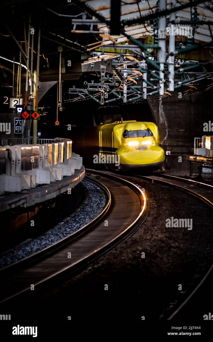 A motion view of yellow bullet train Shinkansen in Shin Kobe Station ...