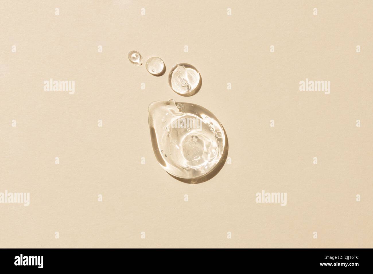 Glycerin gel texture. Transparent serum drop on beige background ...