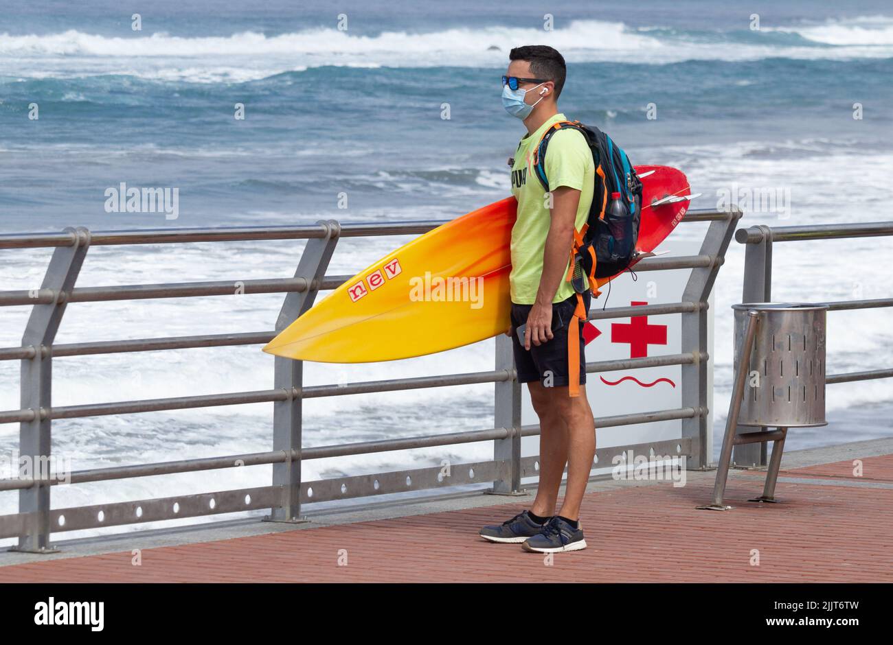 Surfer wearing face covering, mask Stock Photo - Alamy