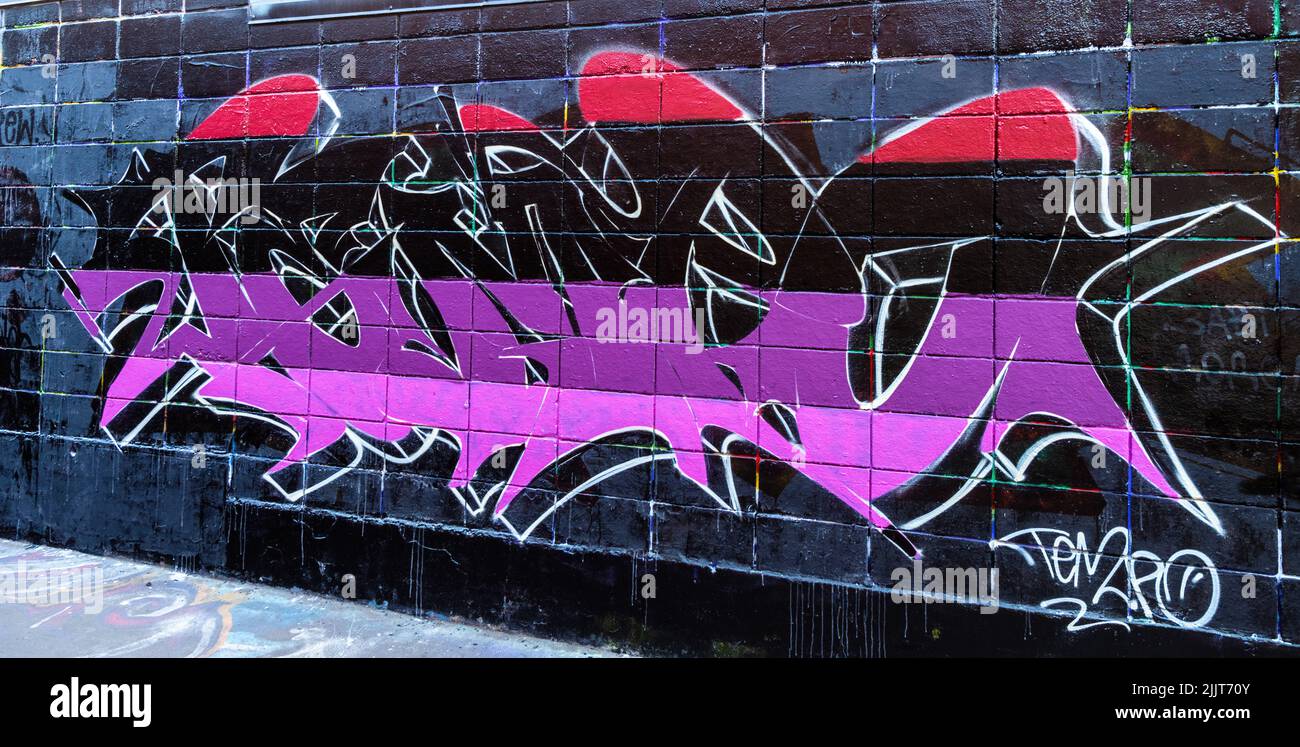 A panoramic shot of social graffiti street art painting of letters with ...