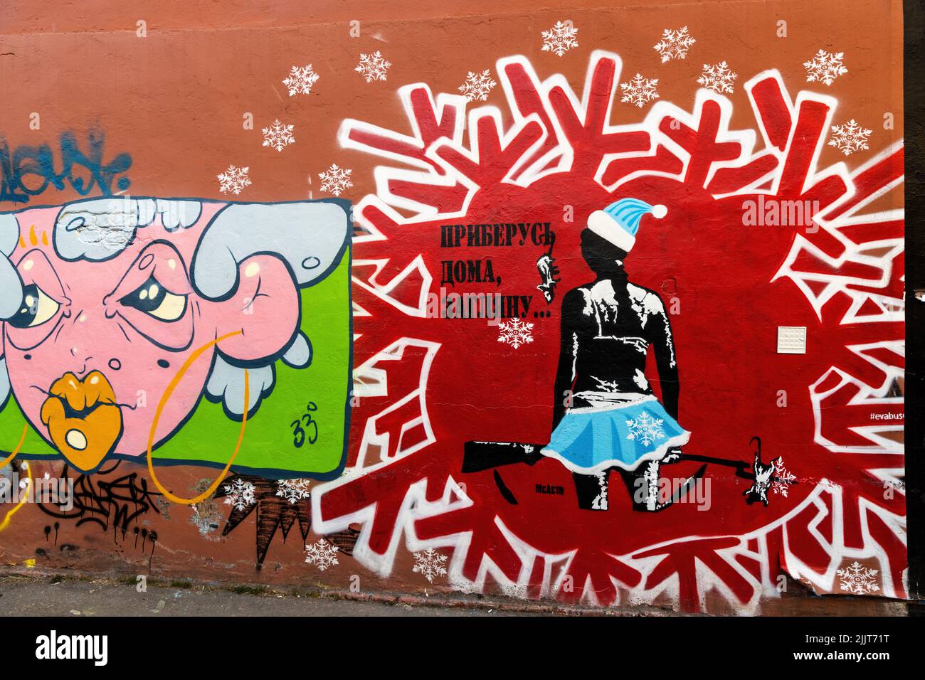 A shot of red and winter-themed social graffiti street art paintings on ...