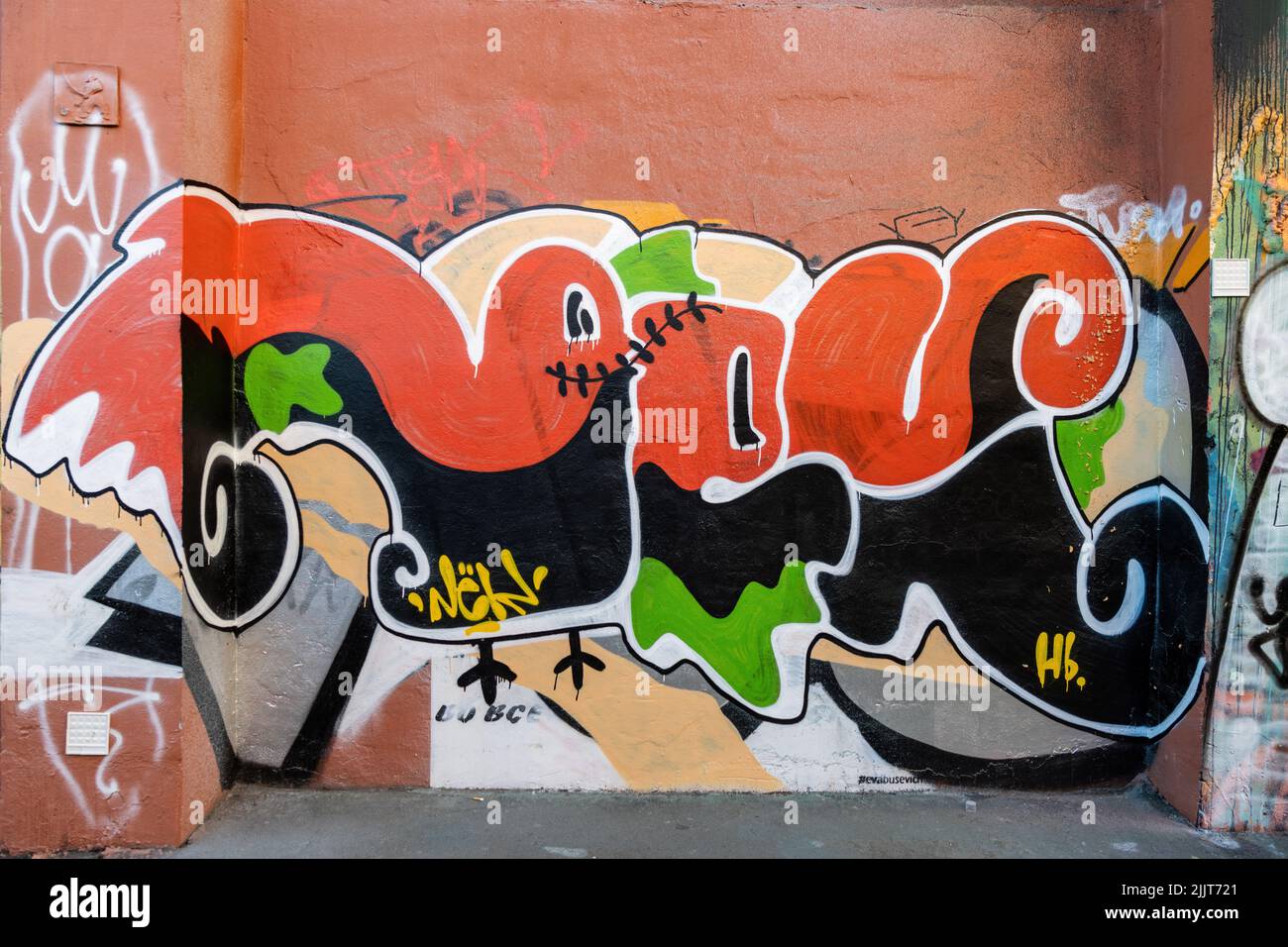 A shot of social graffiti street art paintings on a wall with big ...