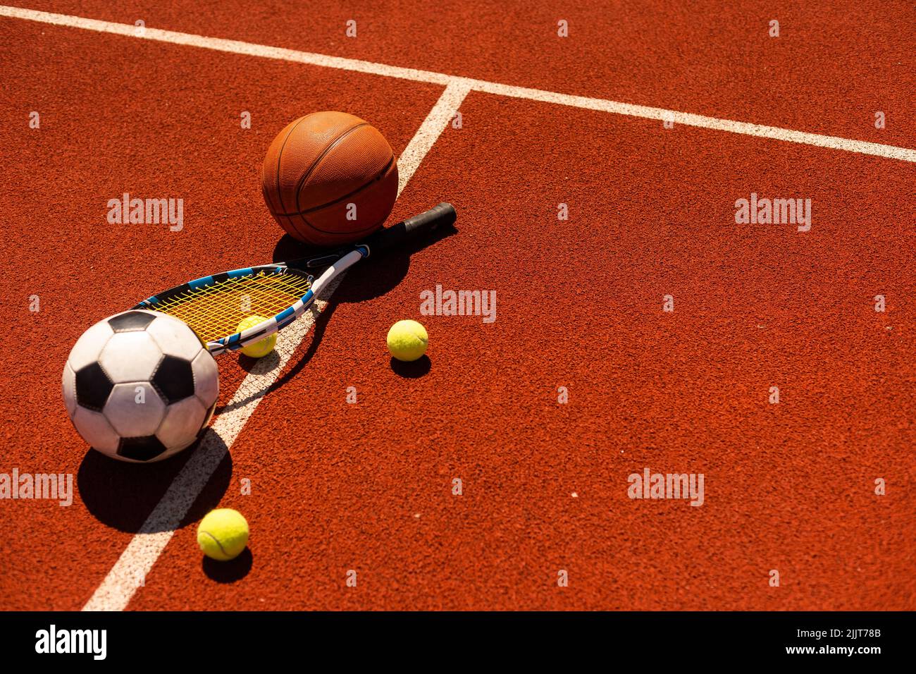 Sport games equipment - balls, rackets - on court Stock Photo - Alamy