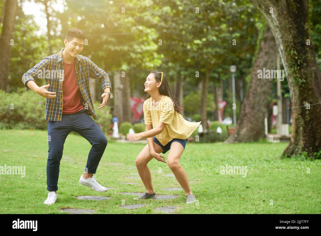 Asian young couple dancing in the park Stock Photo - Alamy